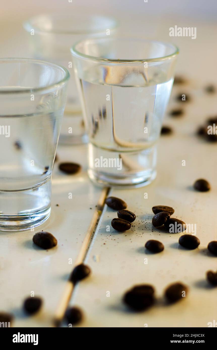Sambuca in shot glasses and coffee beans on white background Stock ...