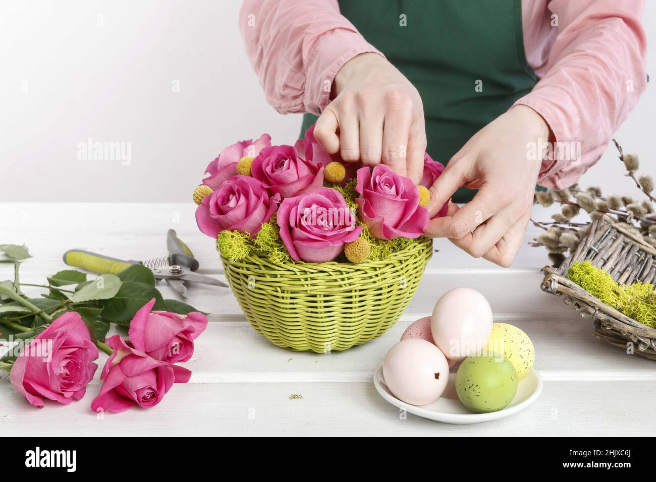 Florist at work: woman shows how to make Easter table decoration with ...