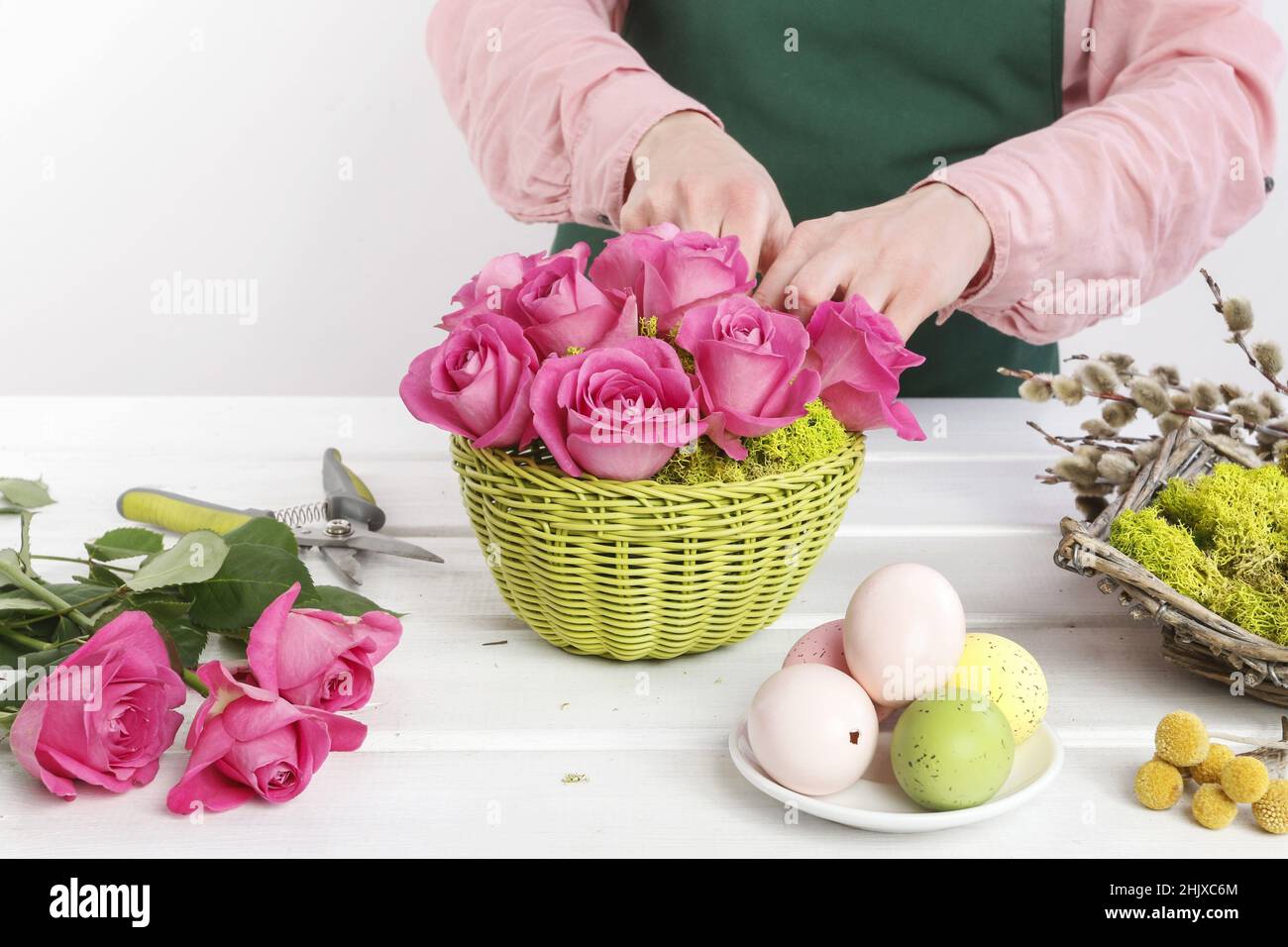 Florist at work: woman shows how to make Easter table decoration with ...