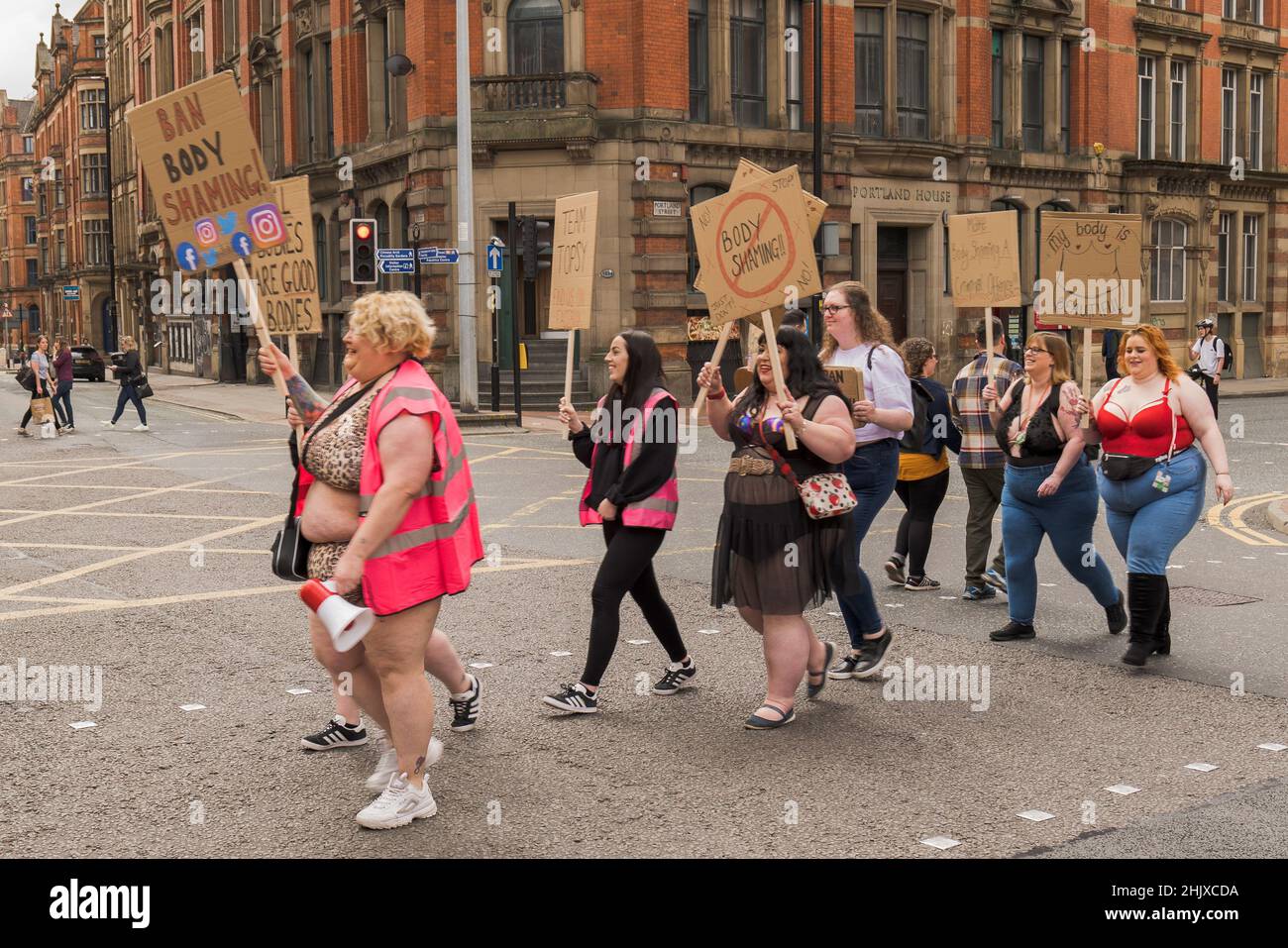 Body Positivity protectors marching down the street with placards ...