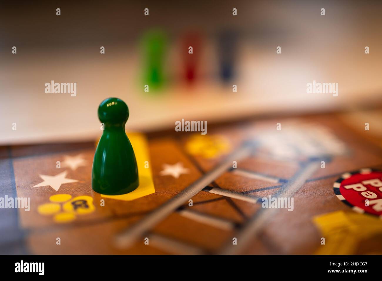 Closeup of the green pawn figure on the board game. Selected focus ...