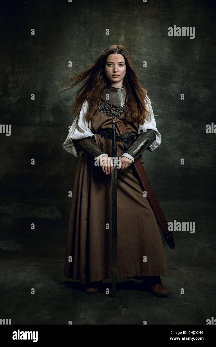 Full-length portrait of seriuos beautiful woman in image of medieval ...