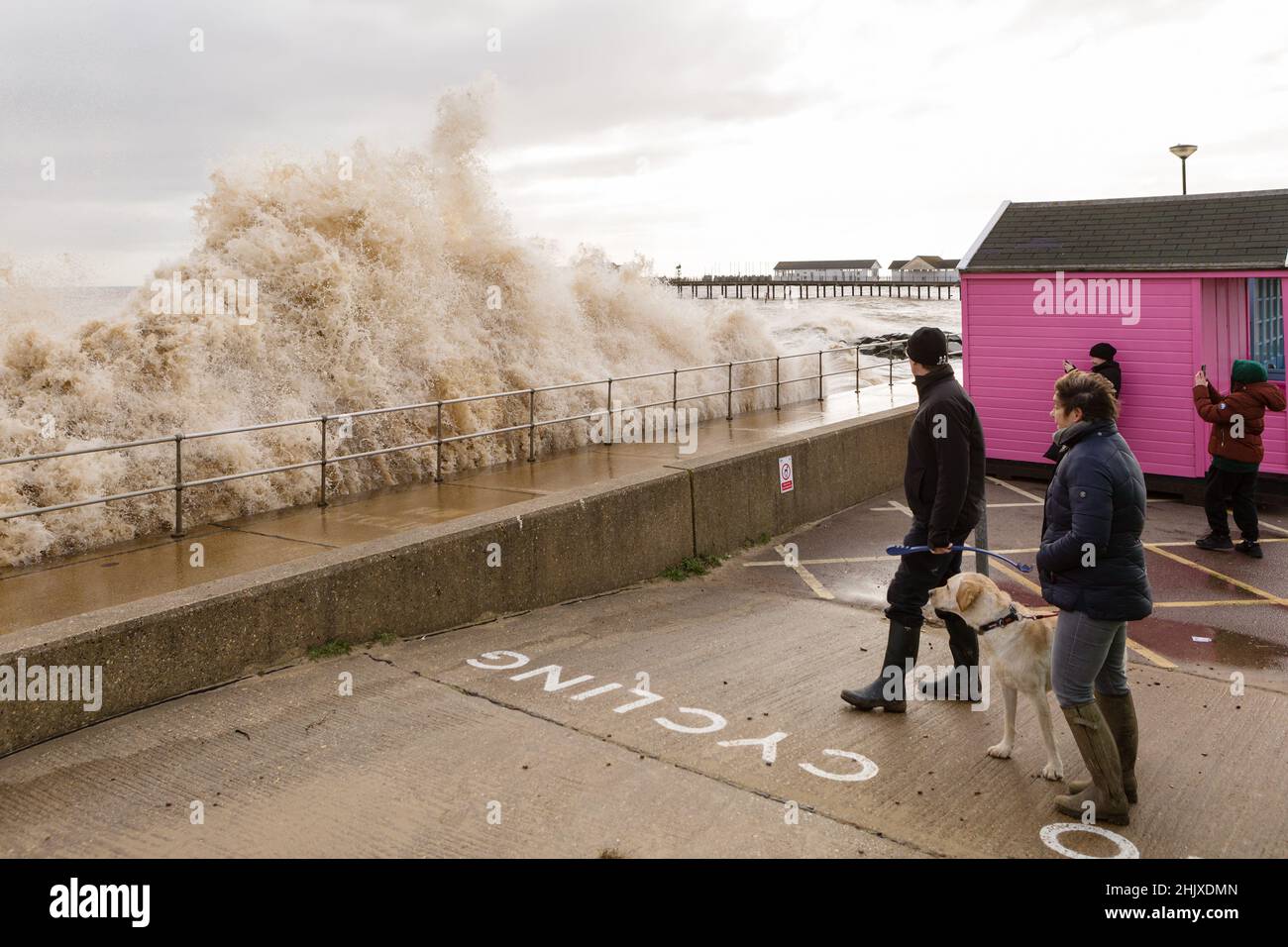 Visitors witness the power of the ocean as waves Crash in to the sea ...
