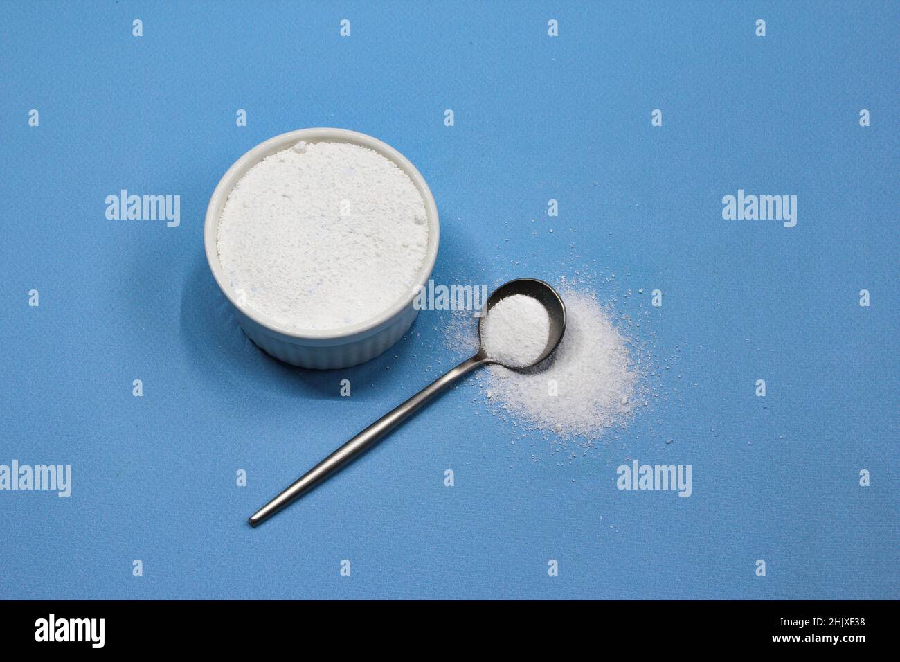 Collagen powder on blue background. Natural health supplement for skin ...