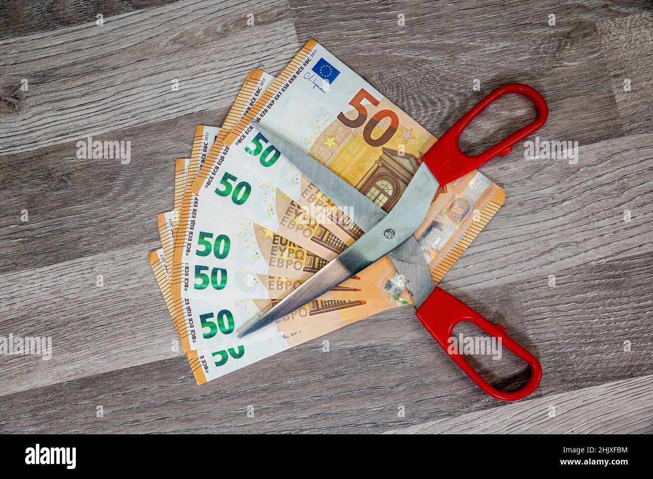 50 euro banknotes with kitchen scissors on top Stock Photo - Alamy