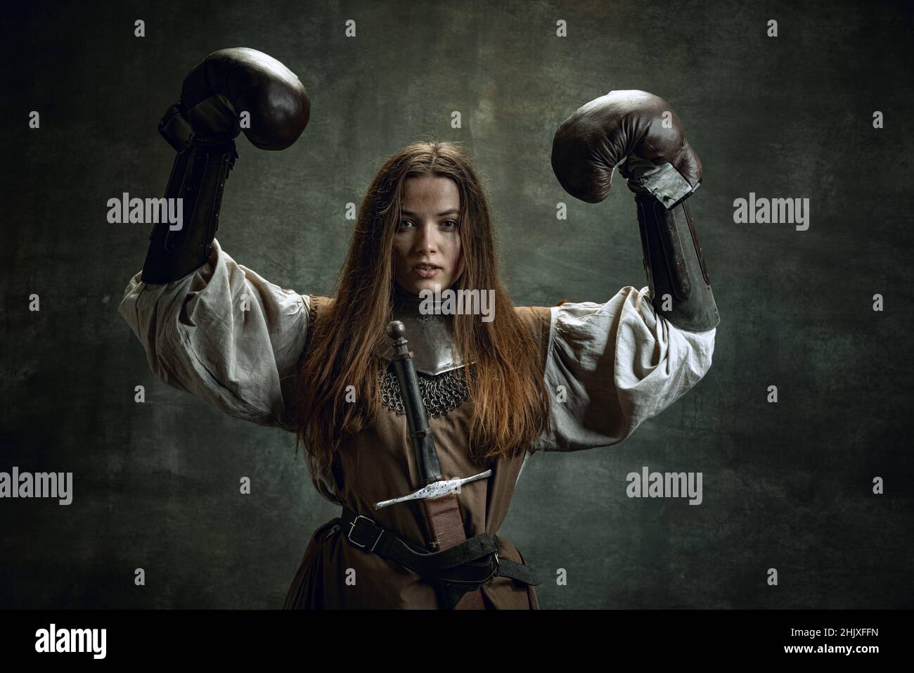 Portrait of brave girl, medieval warrior or knight with dirty wounded ...
