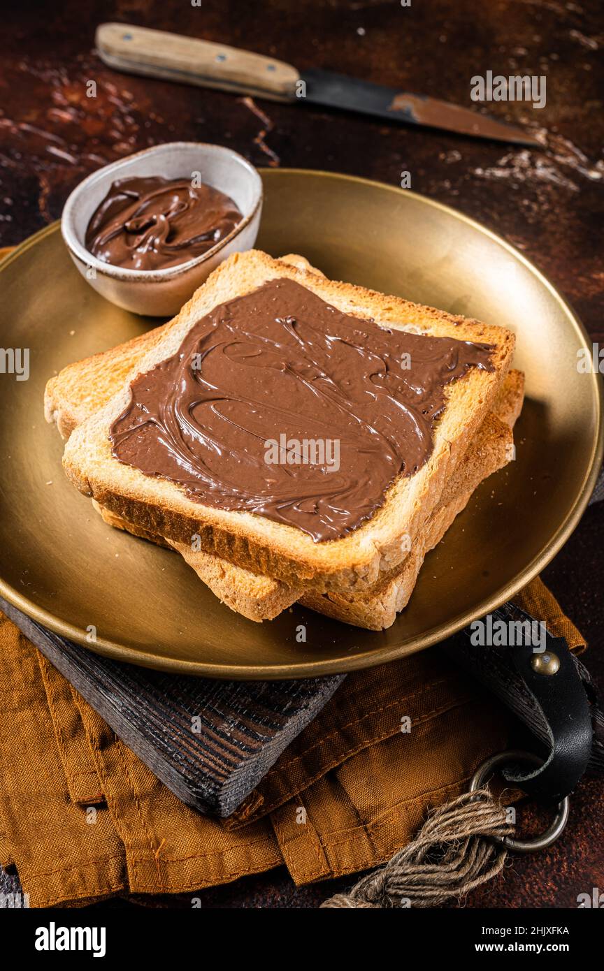 Stack of Toasts with chocolate Hazelnut cream in plate. Dark background ...