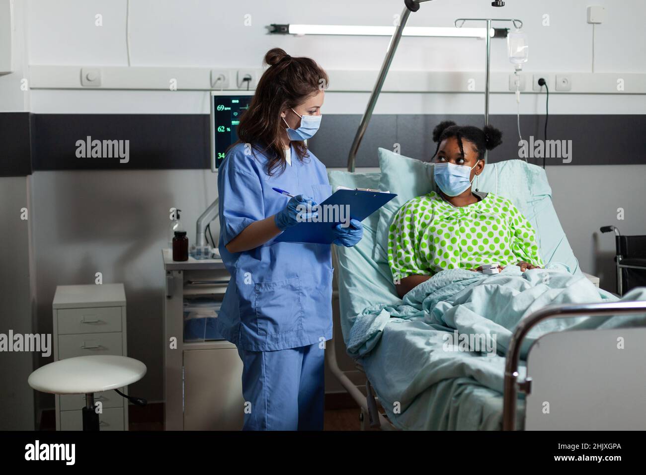 Physician assistant wearing protection face mask to prevent infection ...