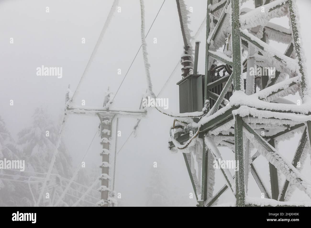 Frozen power line pylons. Hoarfrost on high voltage cables and pylons ...