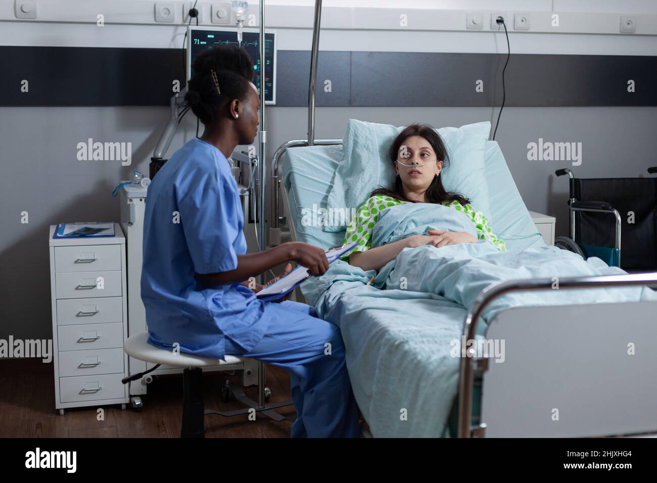 Nurse monitoring patient vital functions during daily visit consulting ...