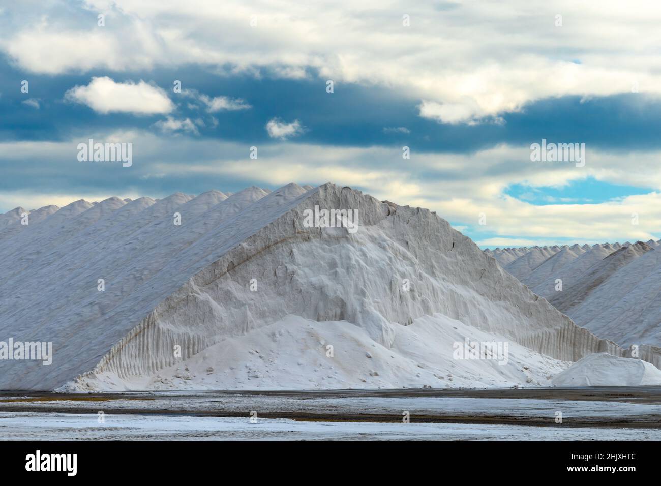 A detail view of large hills of industrial sea salt in the Santa Pola ...