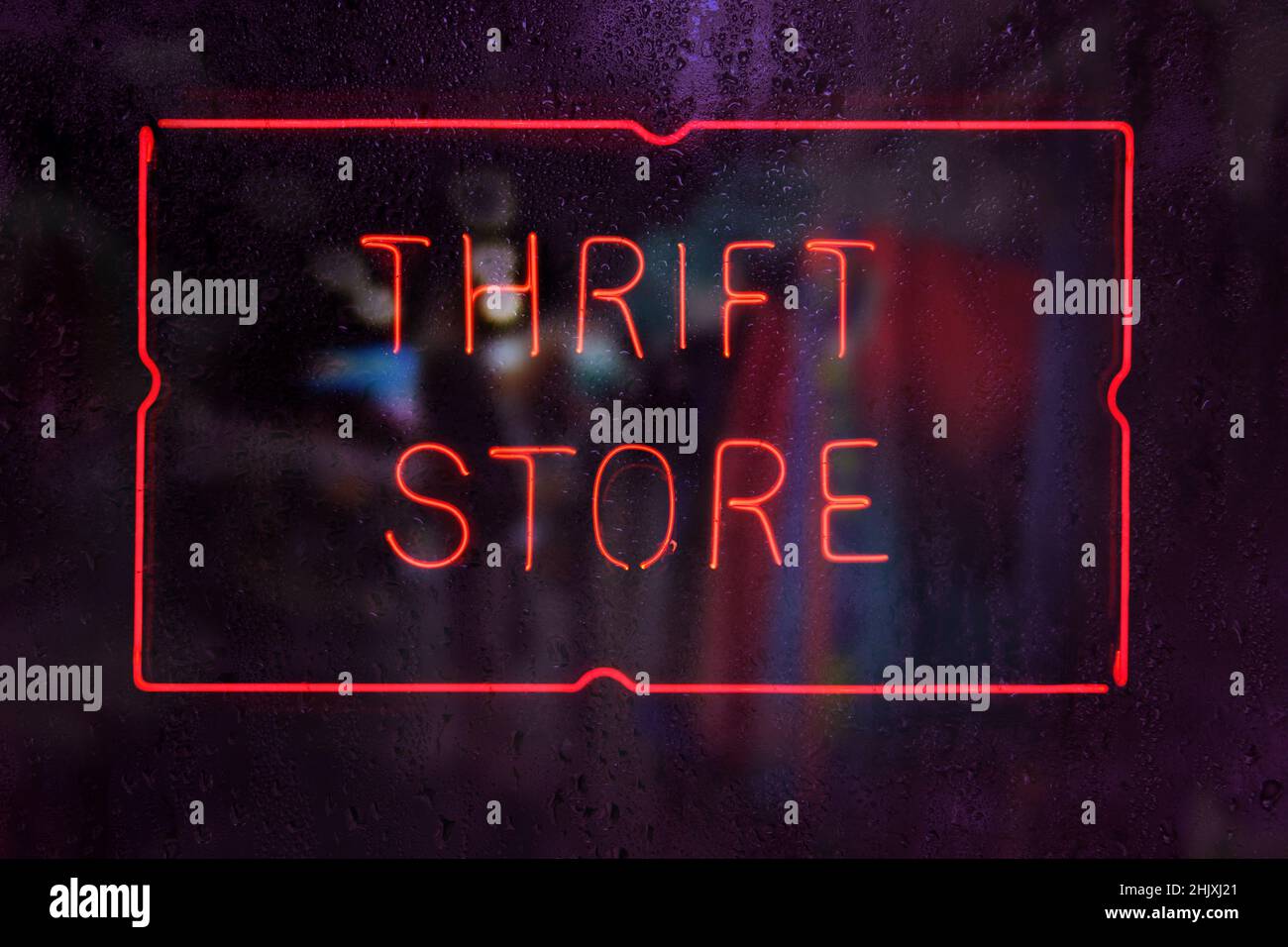 Vintage Neon Thrift Store Sign in Rainy Store Window Stock Photo - Alamy