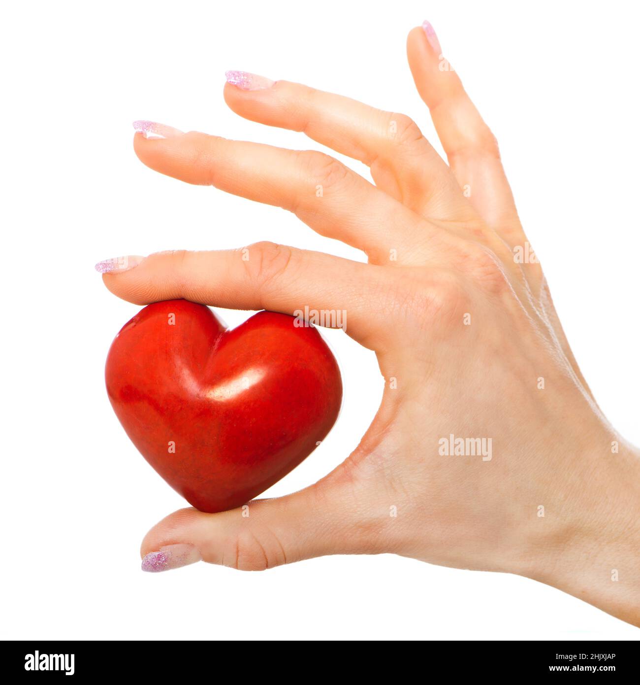 Manicured hands hold a red heart Stock Photo - Alamy
