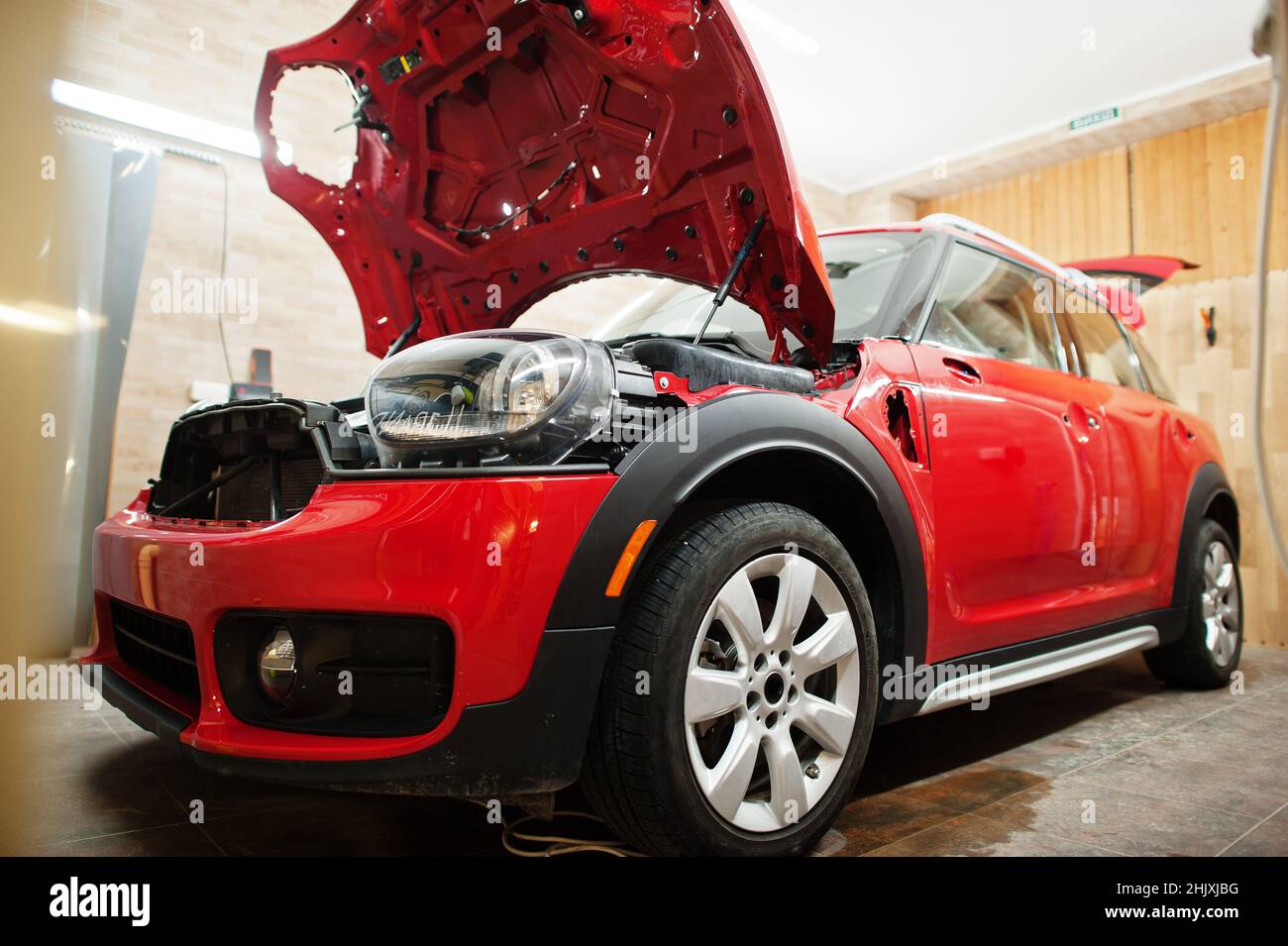 Car service red car body at the detailing vehicle workshop. Car ...