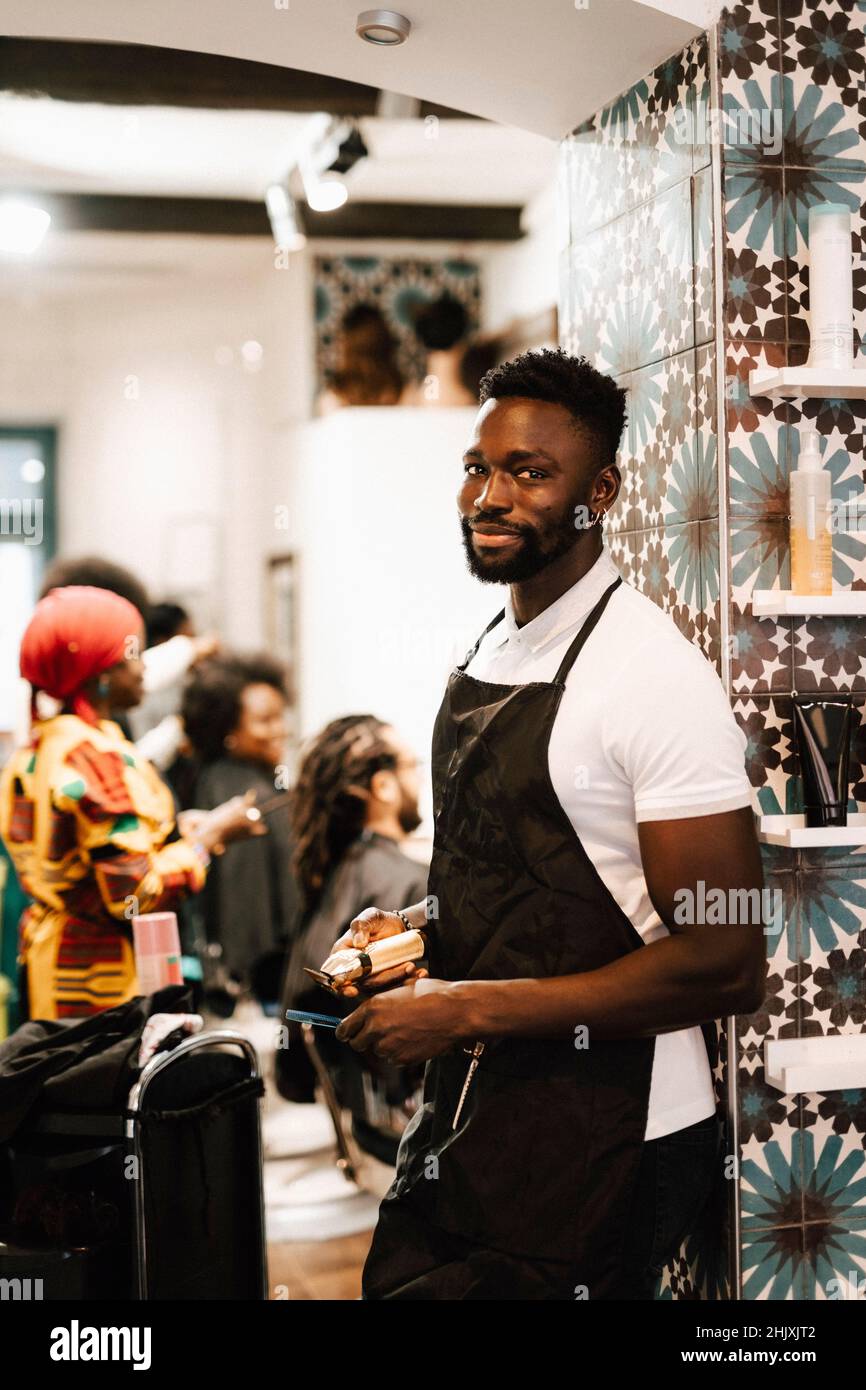 Portrait of male barber standing at hair salon Stock Photo - Alamy