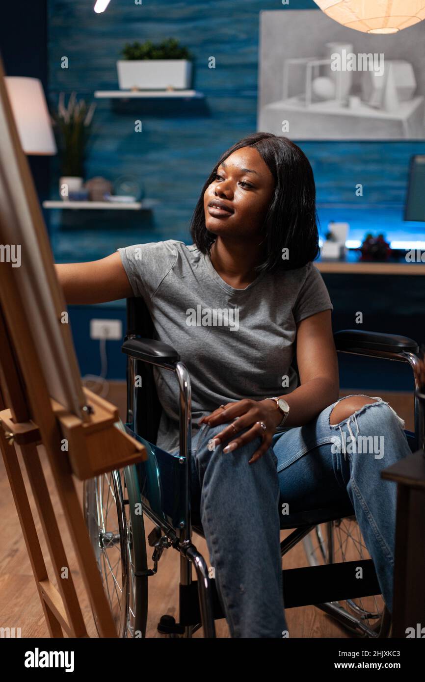 Artist with disability drawing vase using graphic pencil working at ...