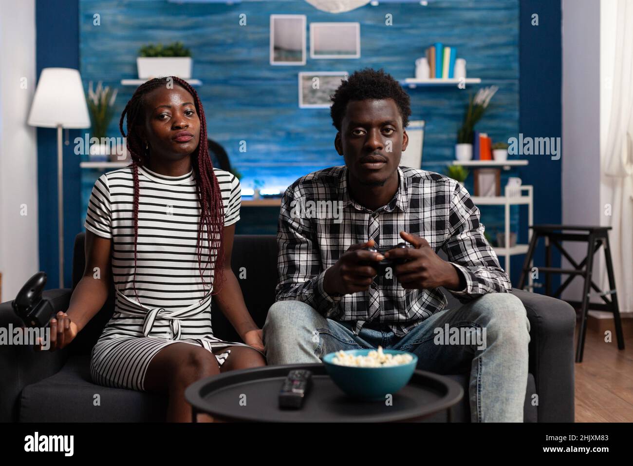 African american man playing video games on console while upset woman ...