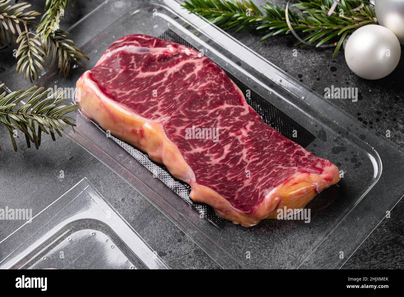 New-York steak pack for the new year set, on black dark stone table ...