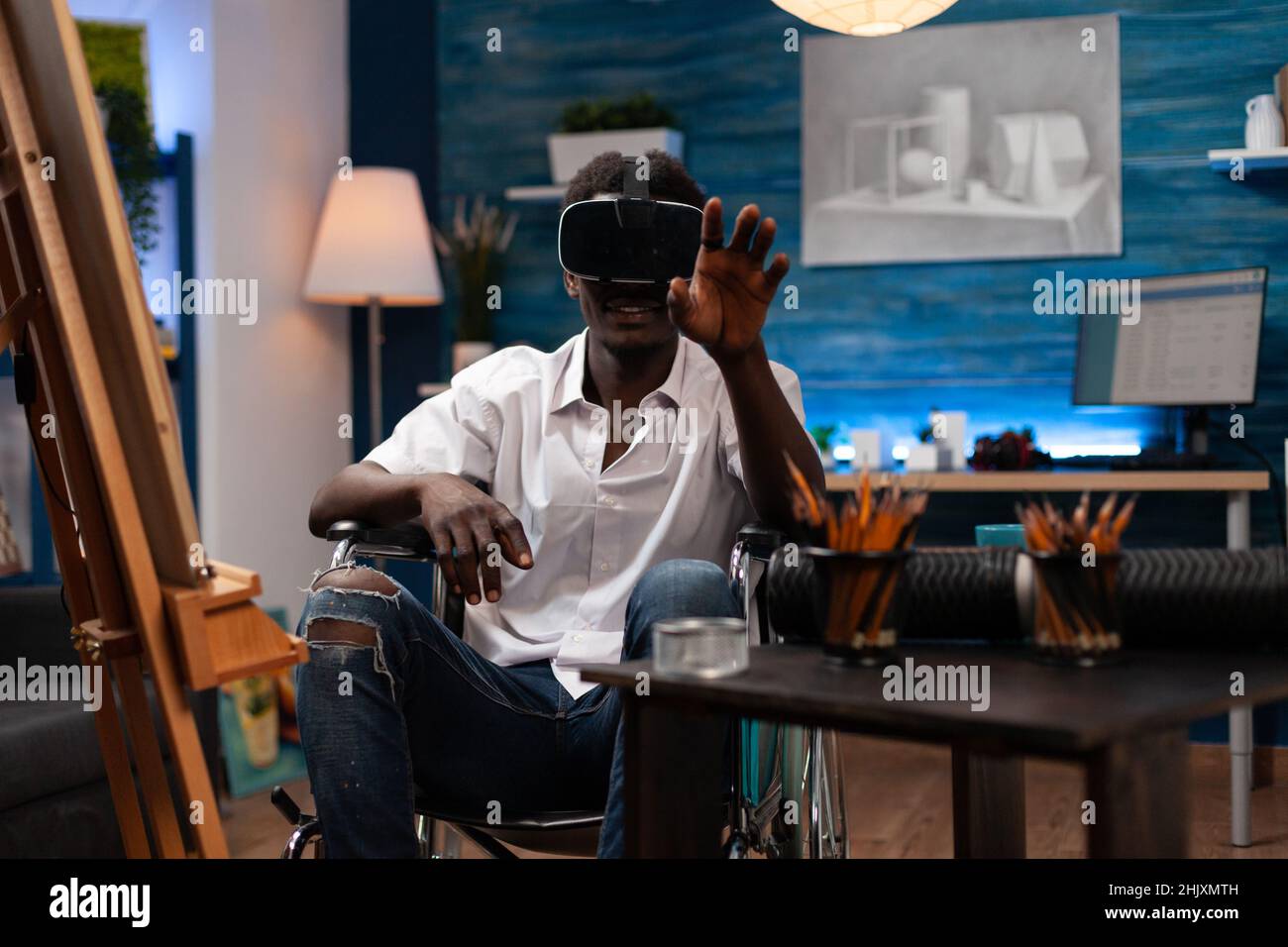 Young artist with virtual reality goggles imagining draw illustration ...