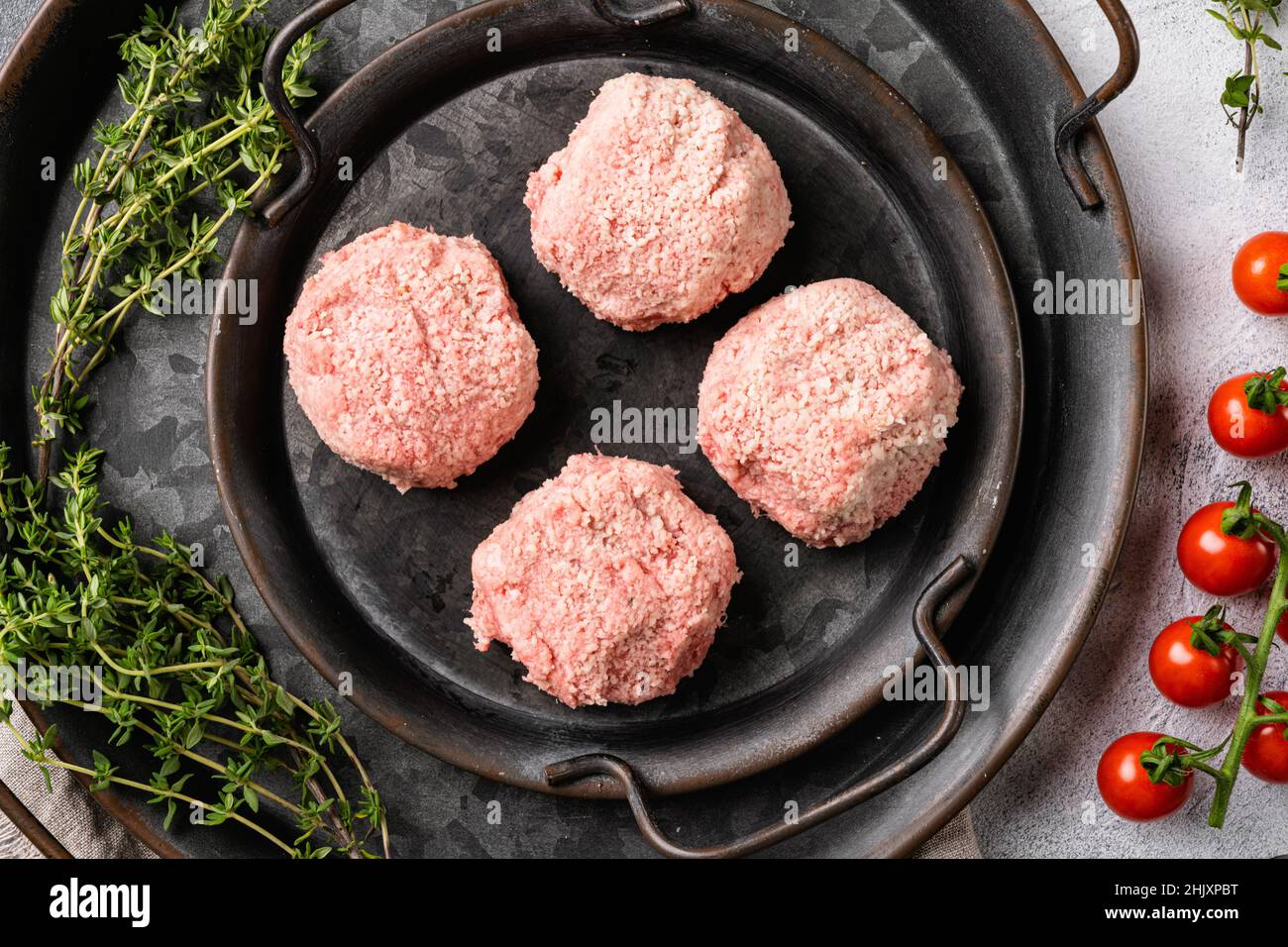 Raw minced meat made into meatballs set, on gray stone table background ...