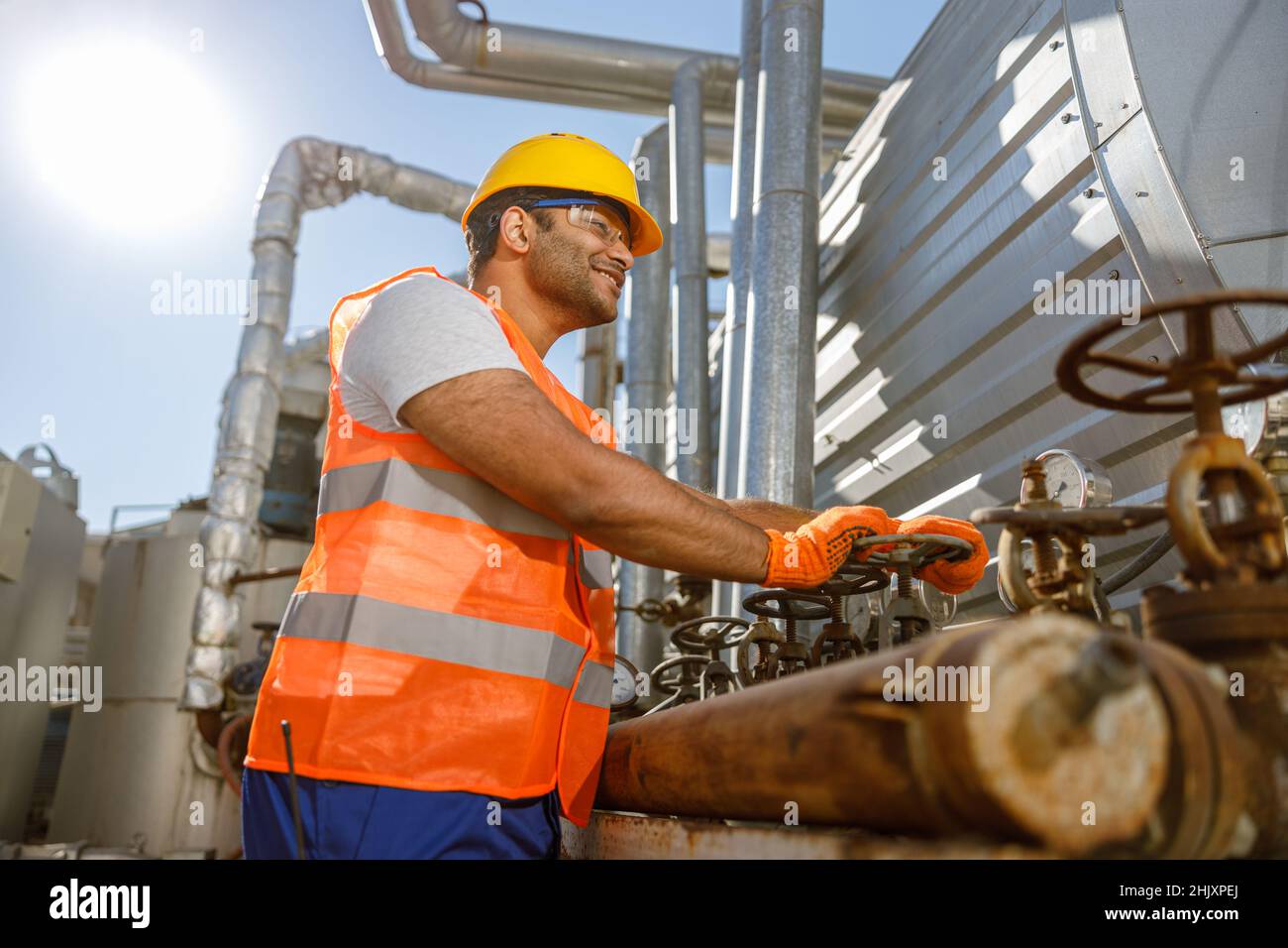Skillful multiethnic engineer working at heavy industry plant Stock ...