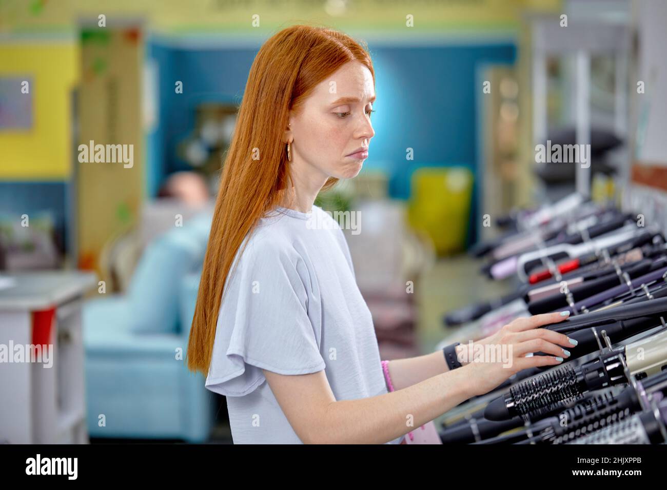 Side View On Young Lady Looking For Curling Iron, Upset By Lack Of ...