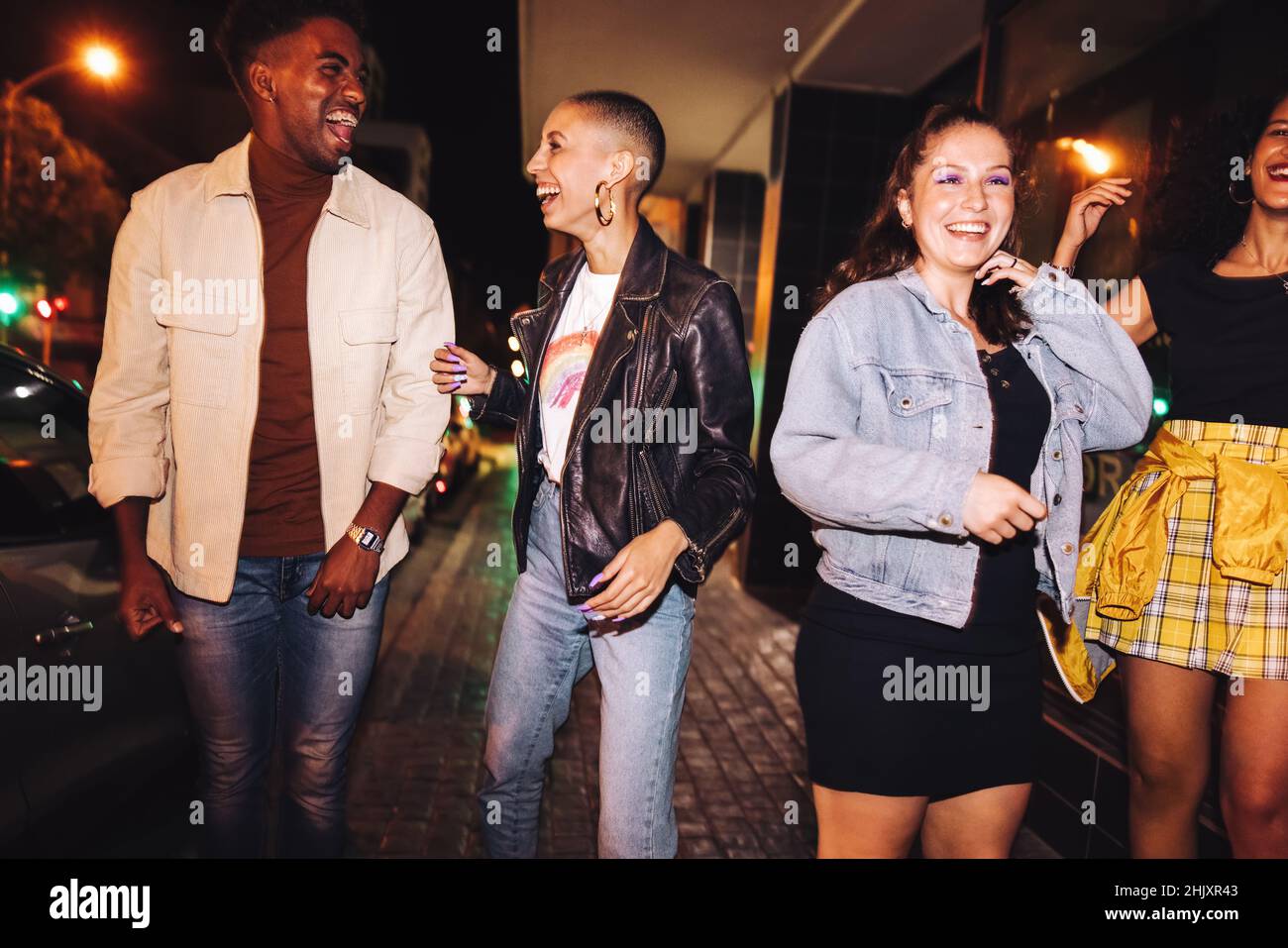 Group of multicultural friends going out together in the city. Happy ...