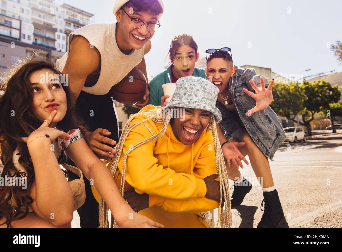 Young people having fun while hanging out together outdoors in the city ...
