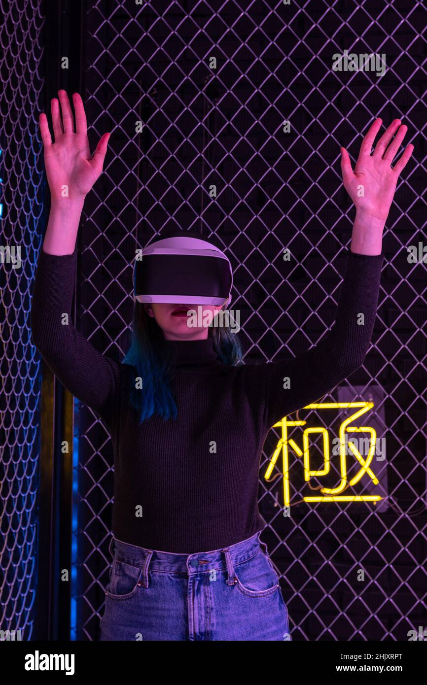 Teen girl using vr headset is in virtual reality cyberspace futuristic ...