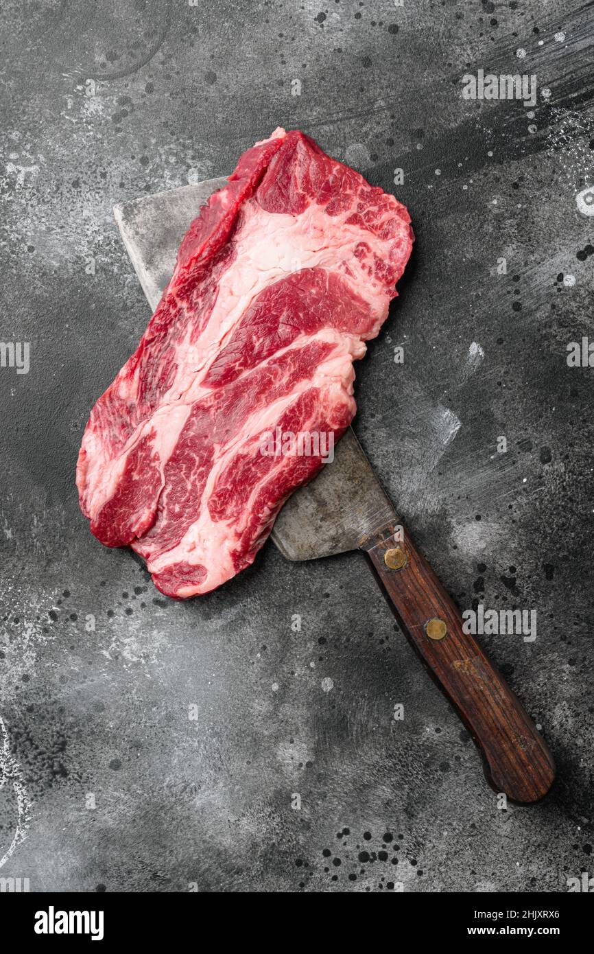 Fresh raw beef marbled steak. Chuck eye roll set, on black dark stone ...