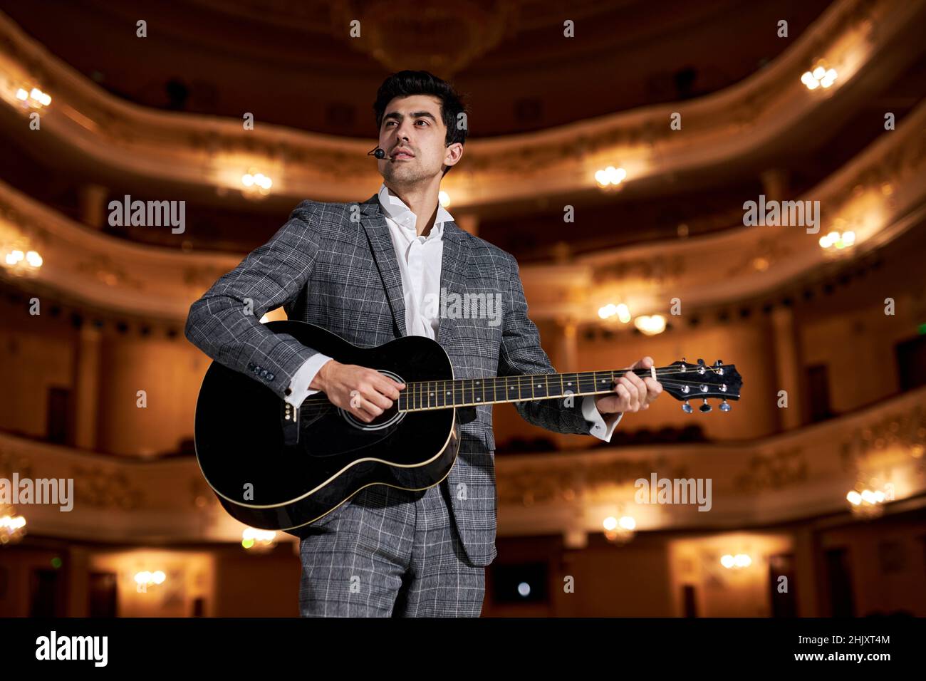 caucasian european Man in elegant classic suit plays and sings while ...