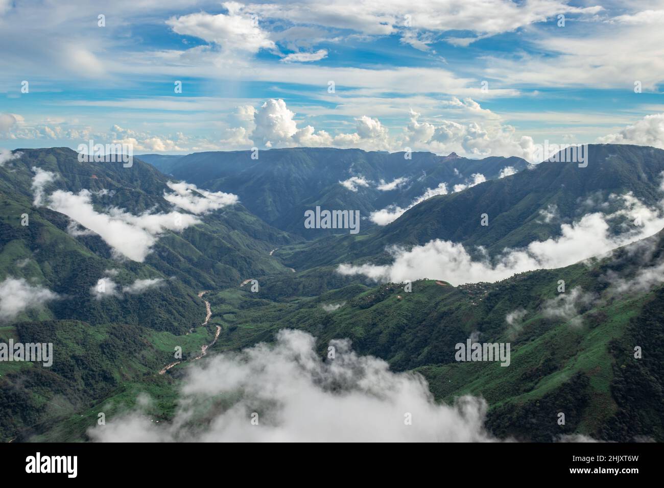 mountain range valley filled with low clouds with dramatic sky at ...