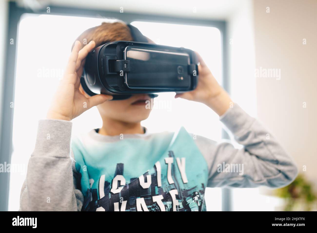 Children experiencing virtual reality at school. Amazed child with ...