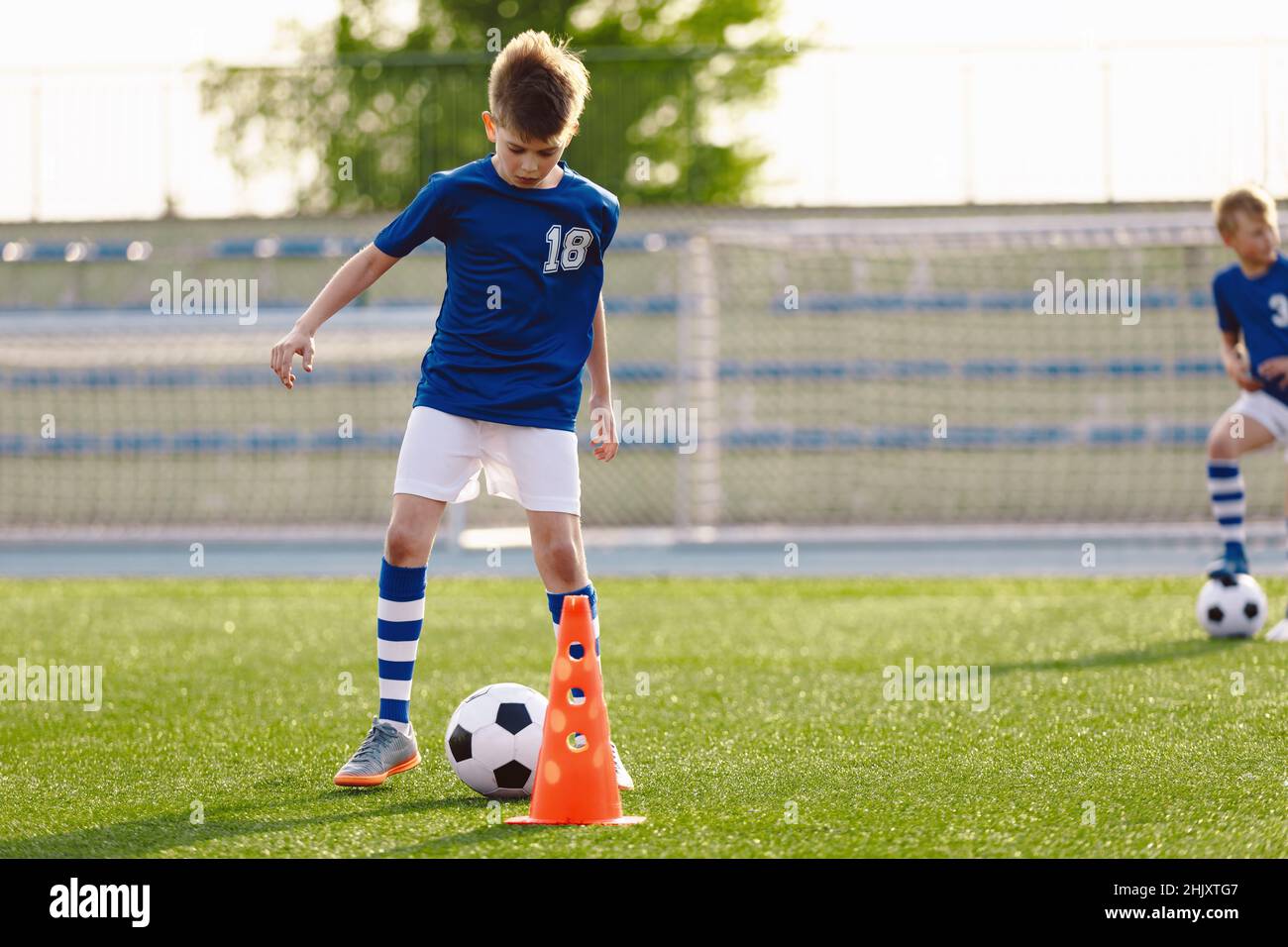 Two children playing soccer on training session. Happy boys practicing ...