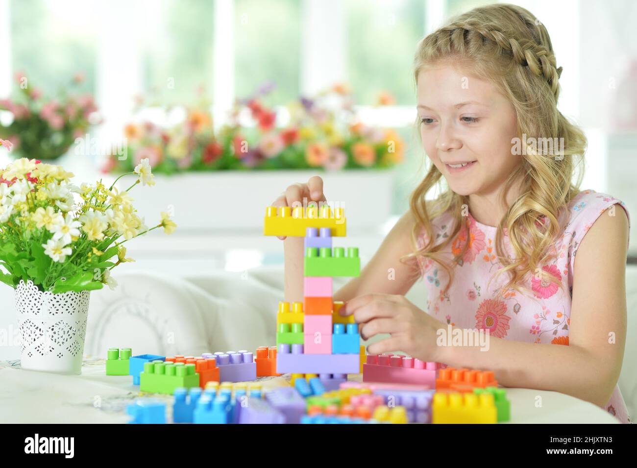Happy cute little girl playing with cubes Stock Photo - Alamy