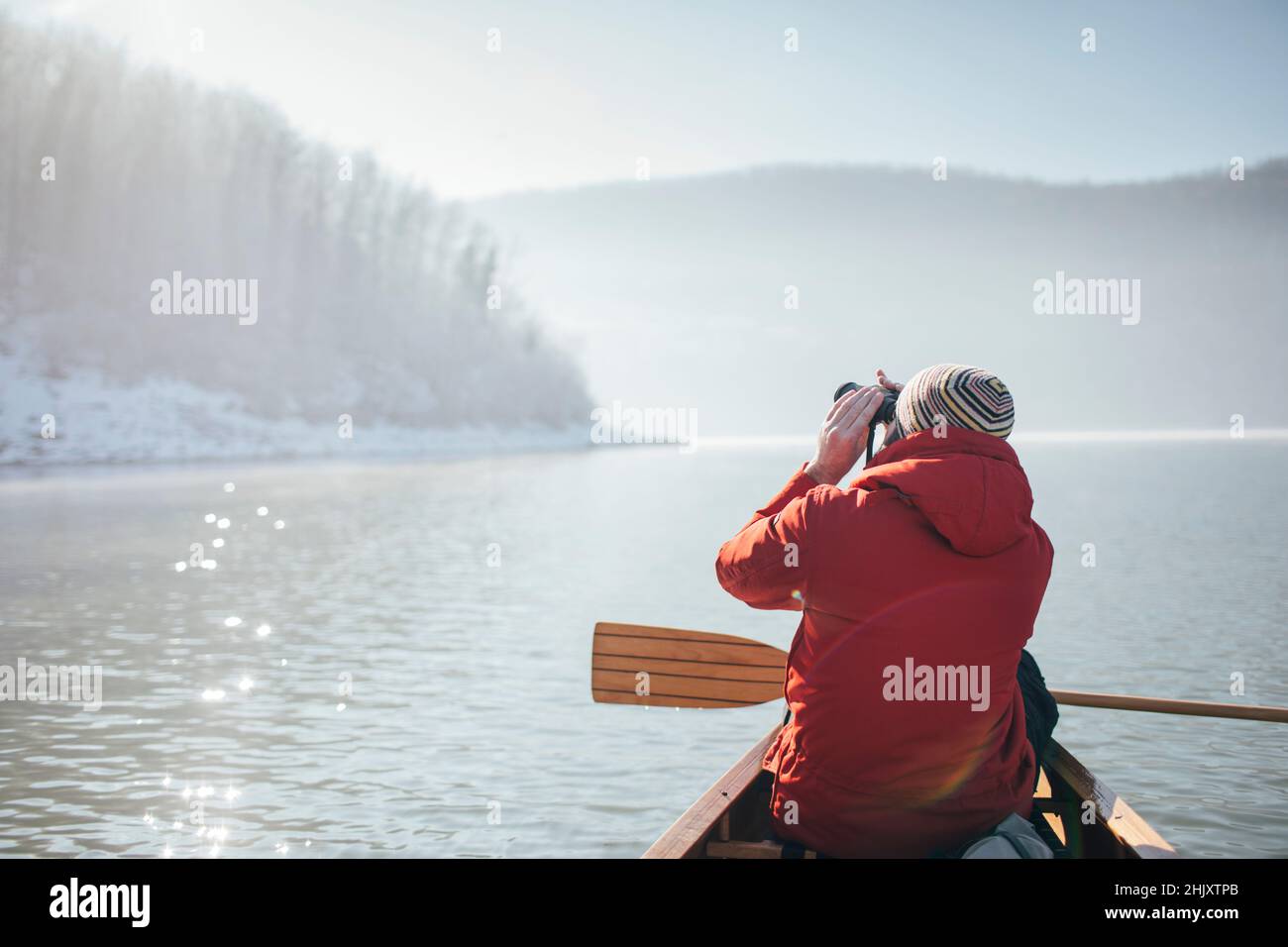 Paddle Birding. Rear view of man watching birds from the canoe Stock ...
