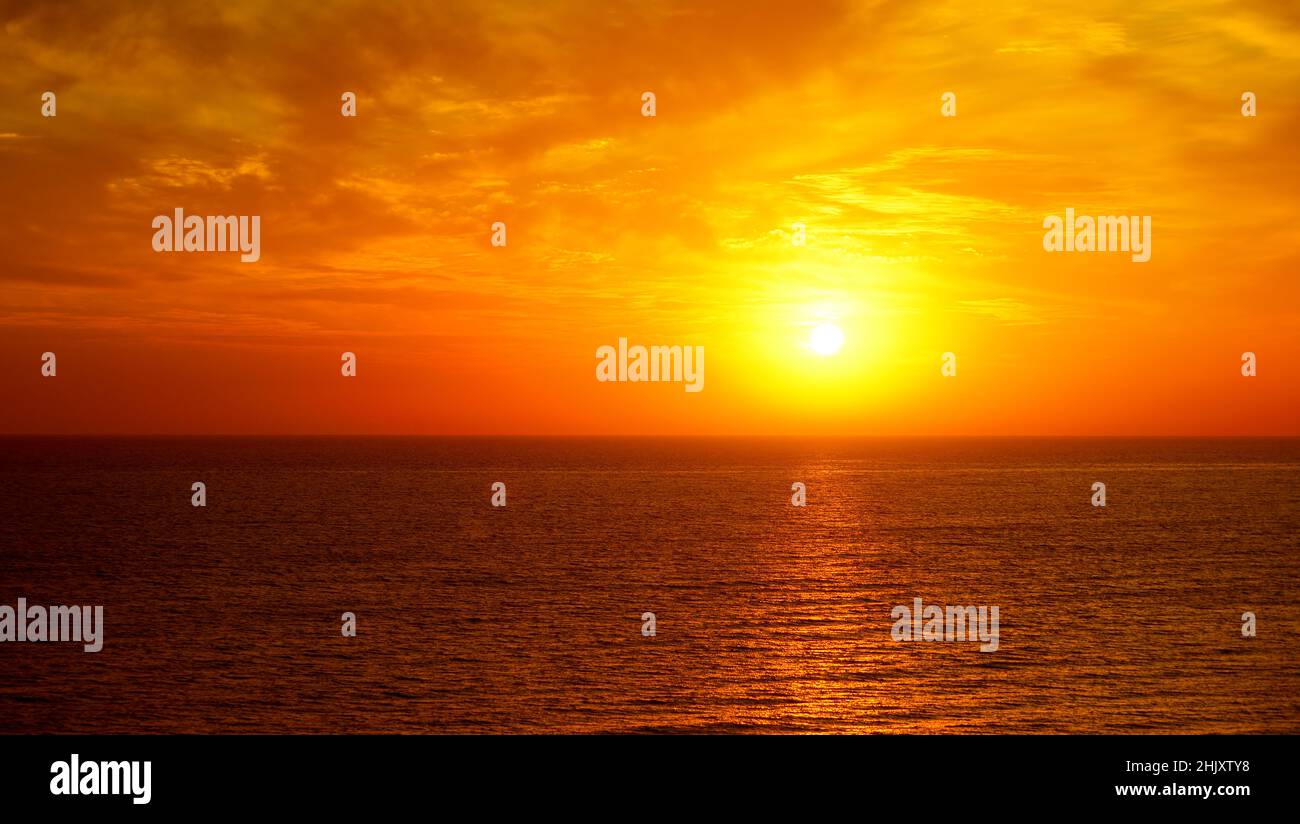 Fantastic ocean and sunset sky in bright red colors Stock Photo - Alamy