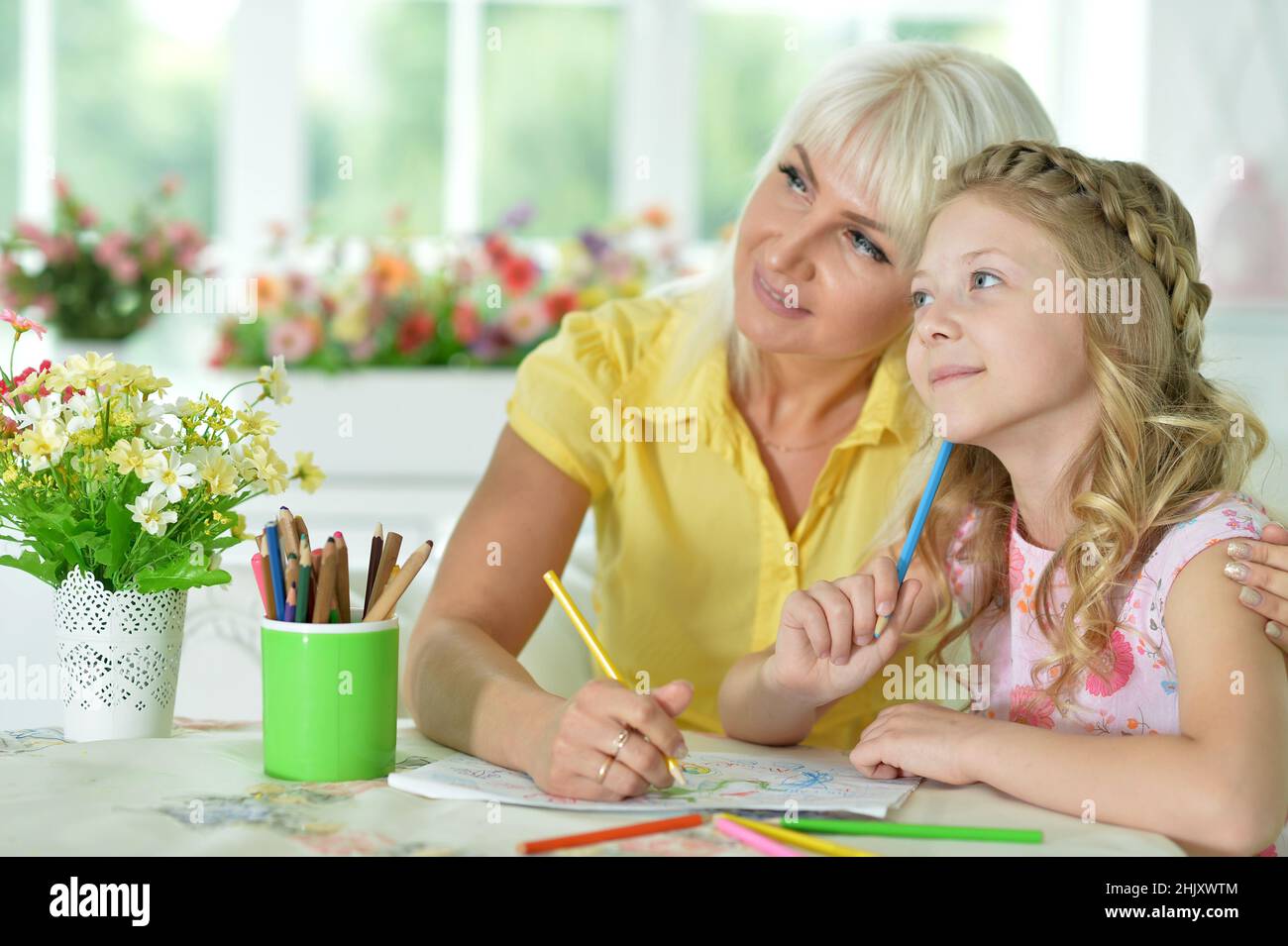 Beautiful mother and daughter drawing with her little girl Stock Photo ...