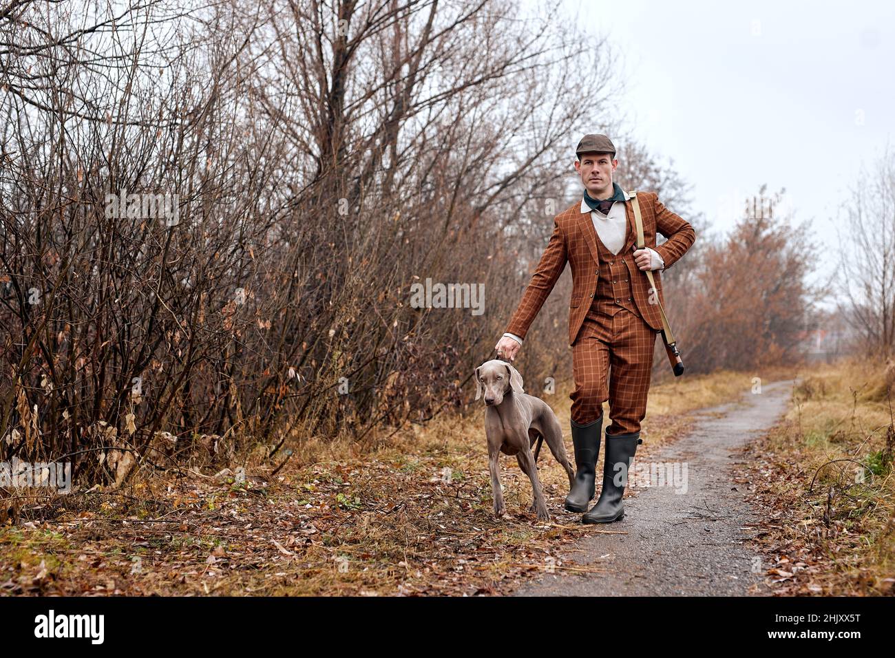 handsome caucasian male hunter in trendy brown suit ready to hunt ...
