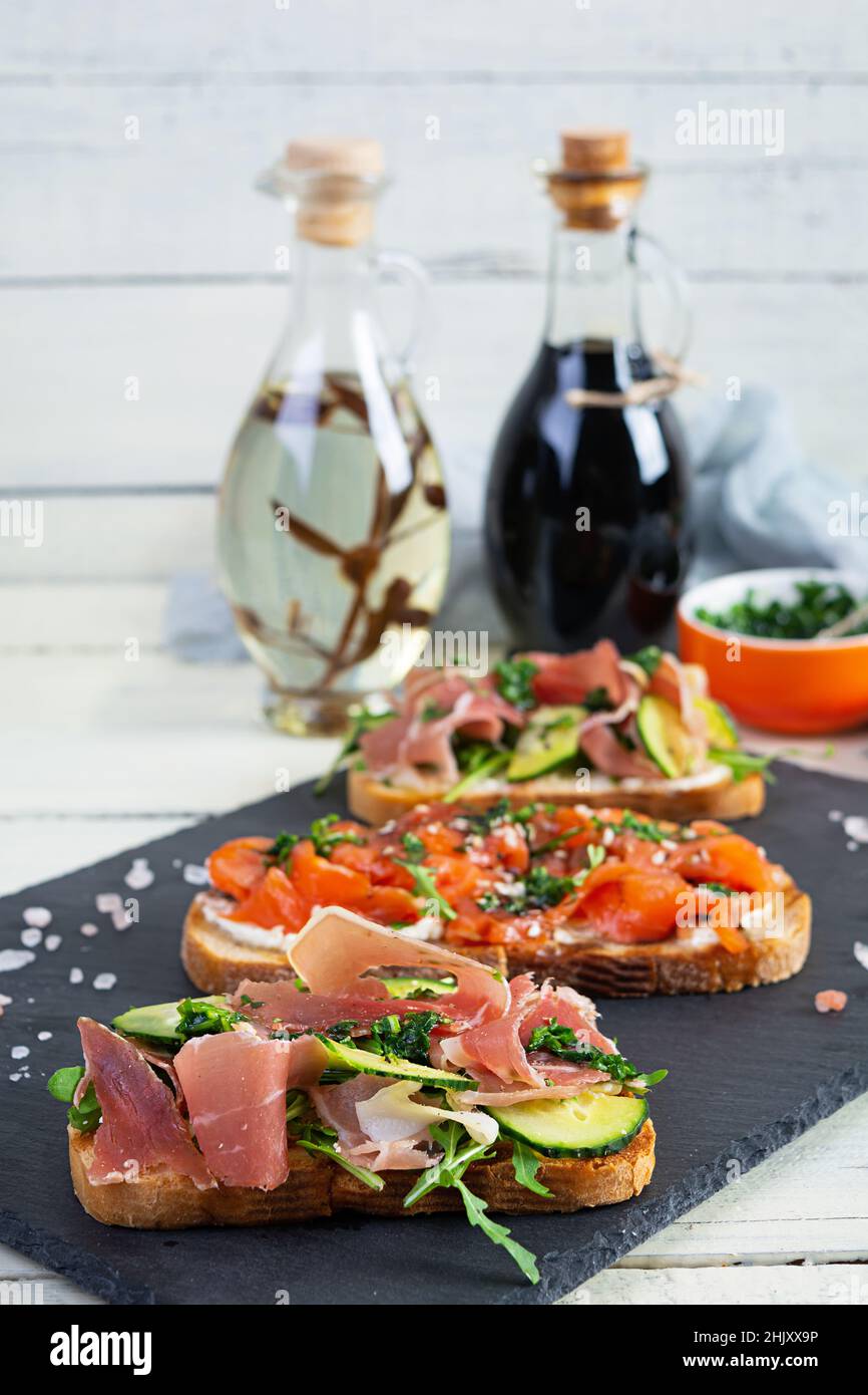 Grilled bruschetta with salmon fillet and jamon. Delicious Italian ...