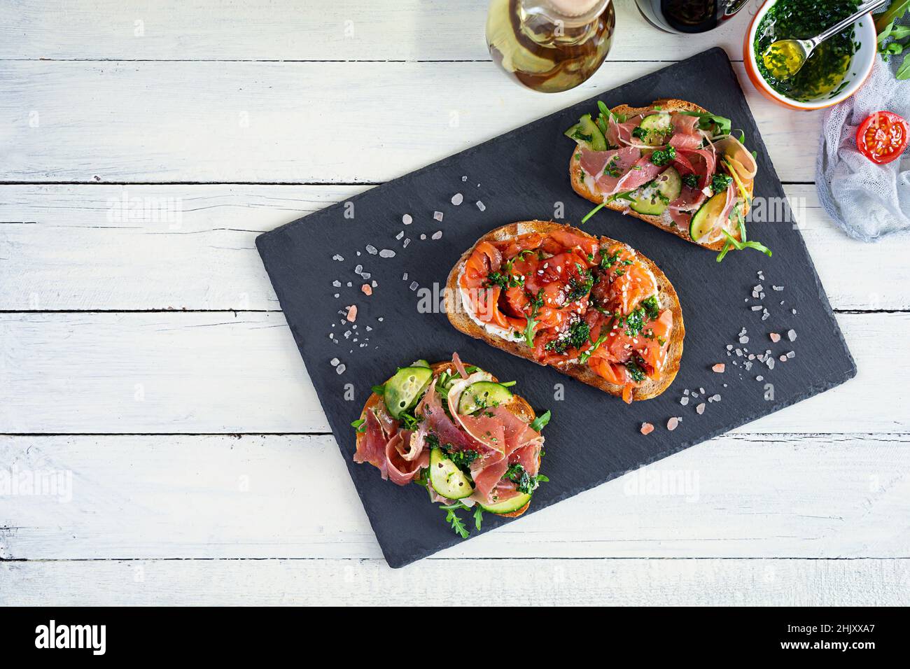 Grilled bruschetta with salmon fillet and jamon. Delicious Italian ...