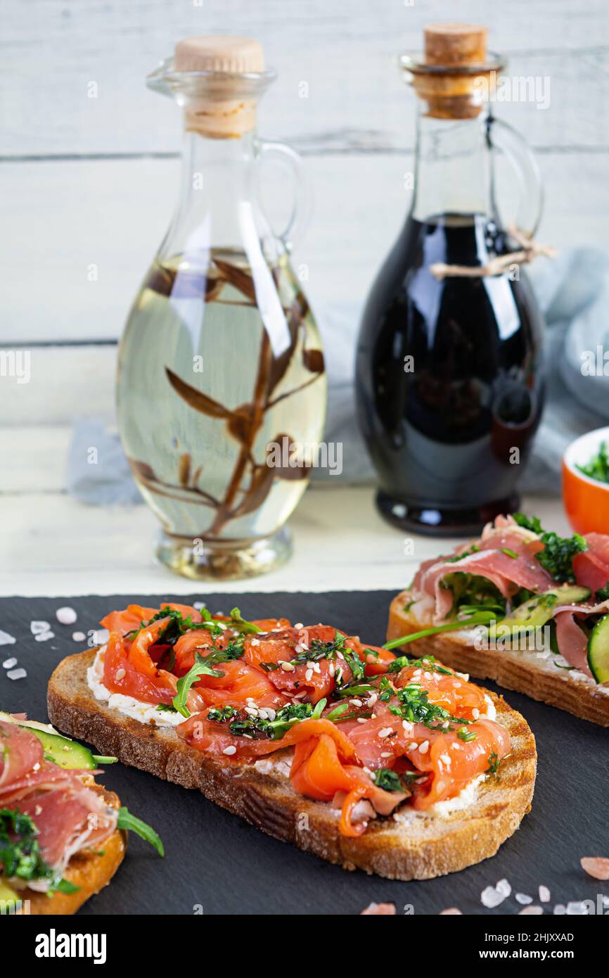 Grilled bruschetta with salmon fillet and jamon. Delicious Italian ...