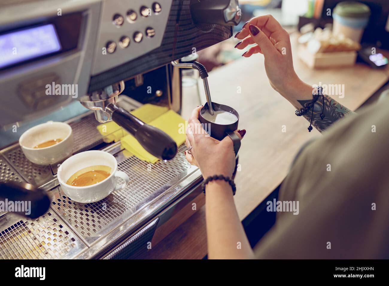 Female barista using coffee machine in coffee shop Stock Photo - Alamy