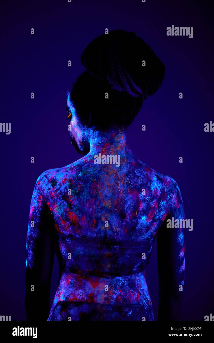 slim black female with luminescence, fluorescence, body art isolated on ...