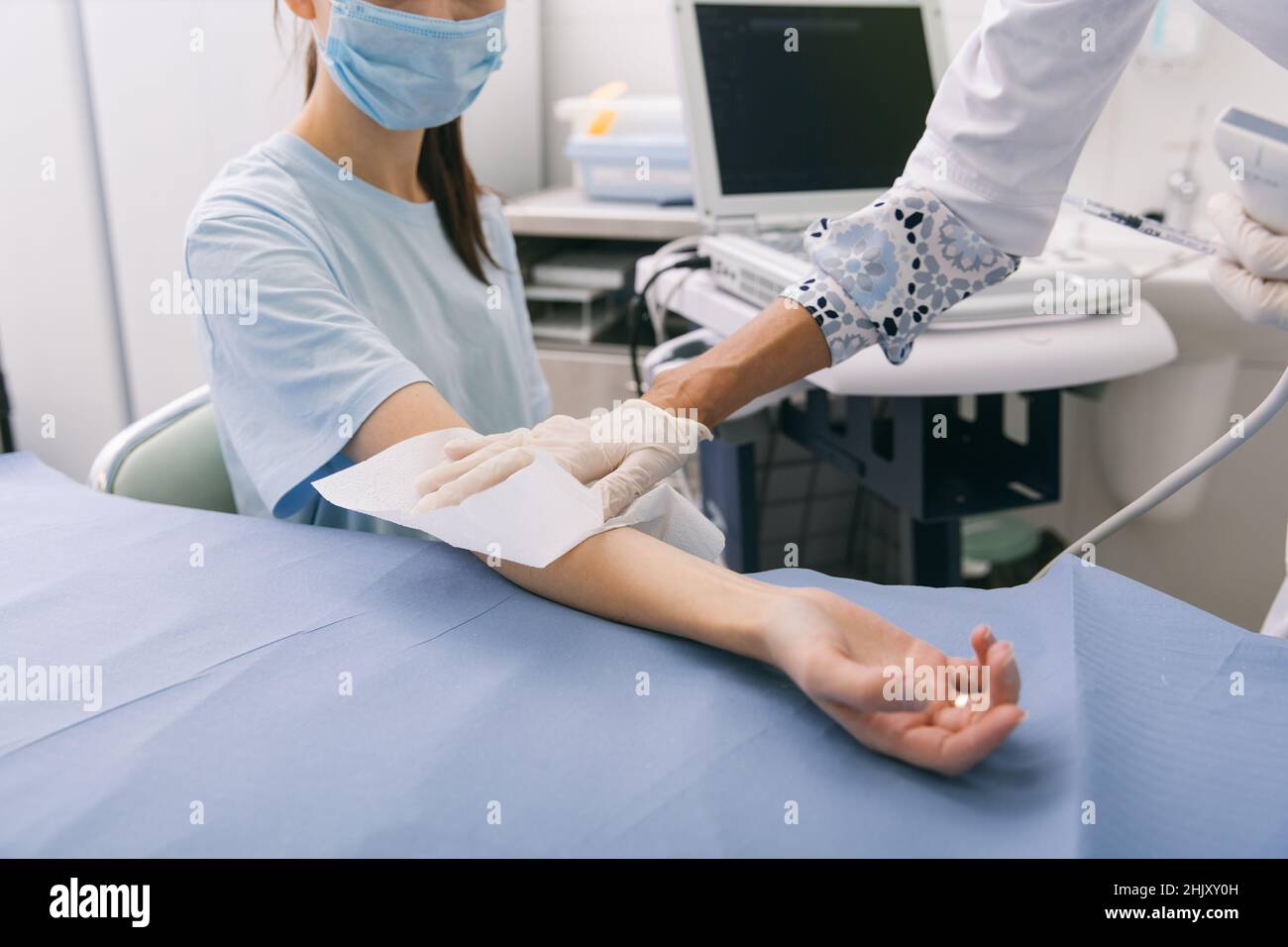 Doctor doing the ultrasound on the hand close up. Doctor demonstrates ...