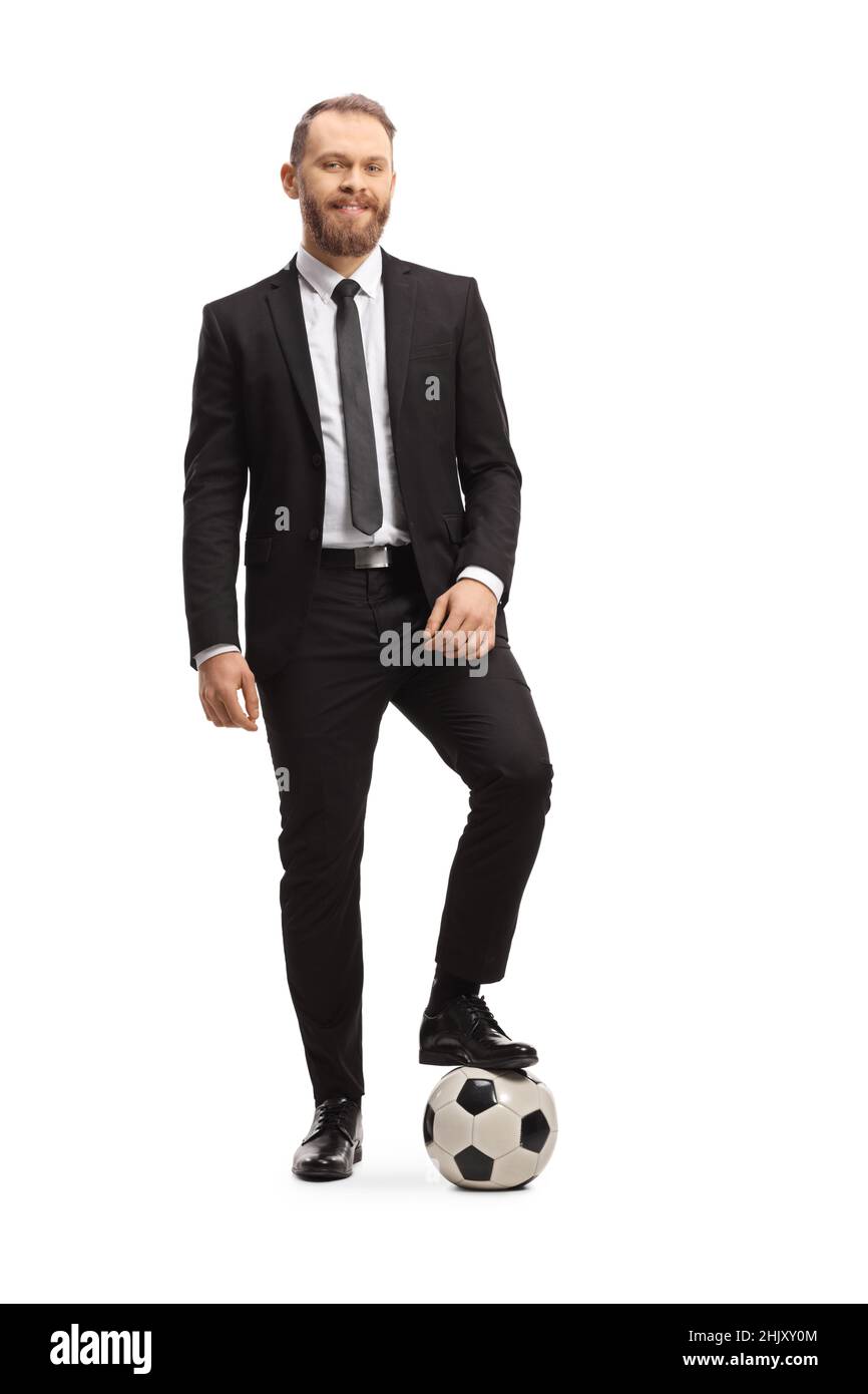 Full length portrait of a young man in a suit and tie posing with a ...