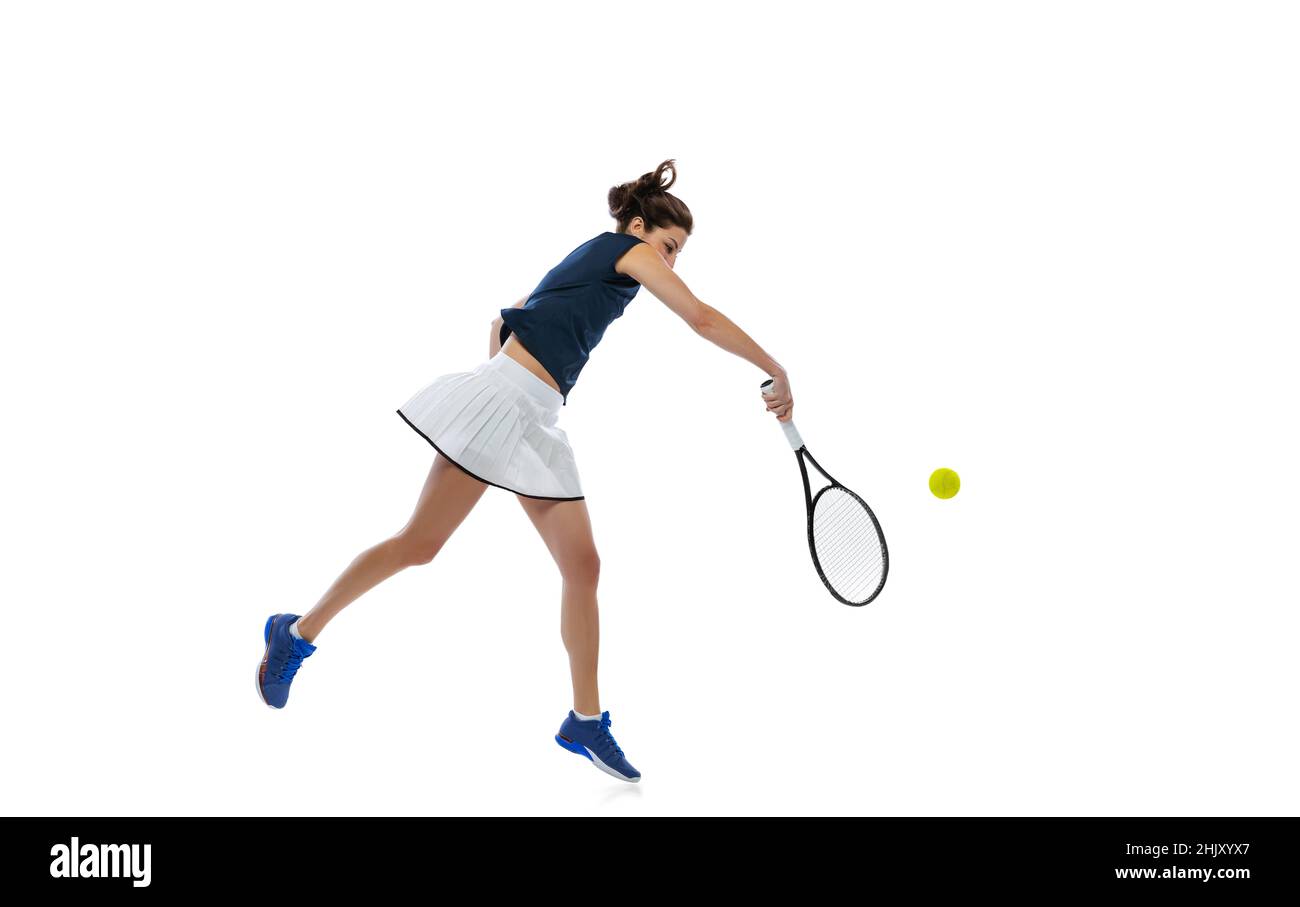 Studio shot of young sportive woman, tennis player training alone ...