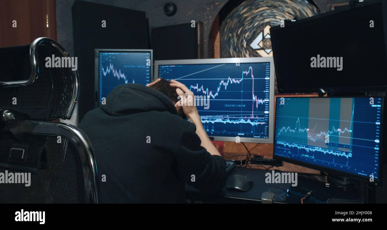 Man trader on stock exchange sees drop in quotation chart and gets very ...