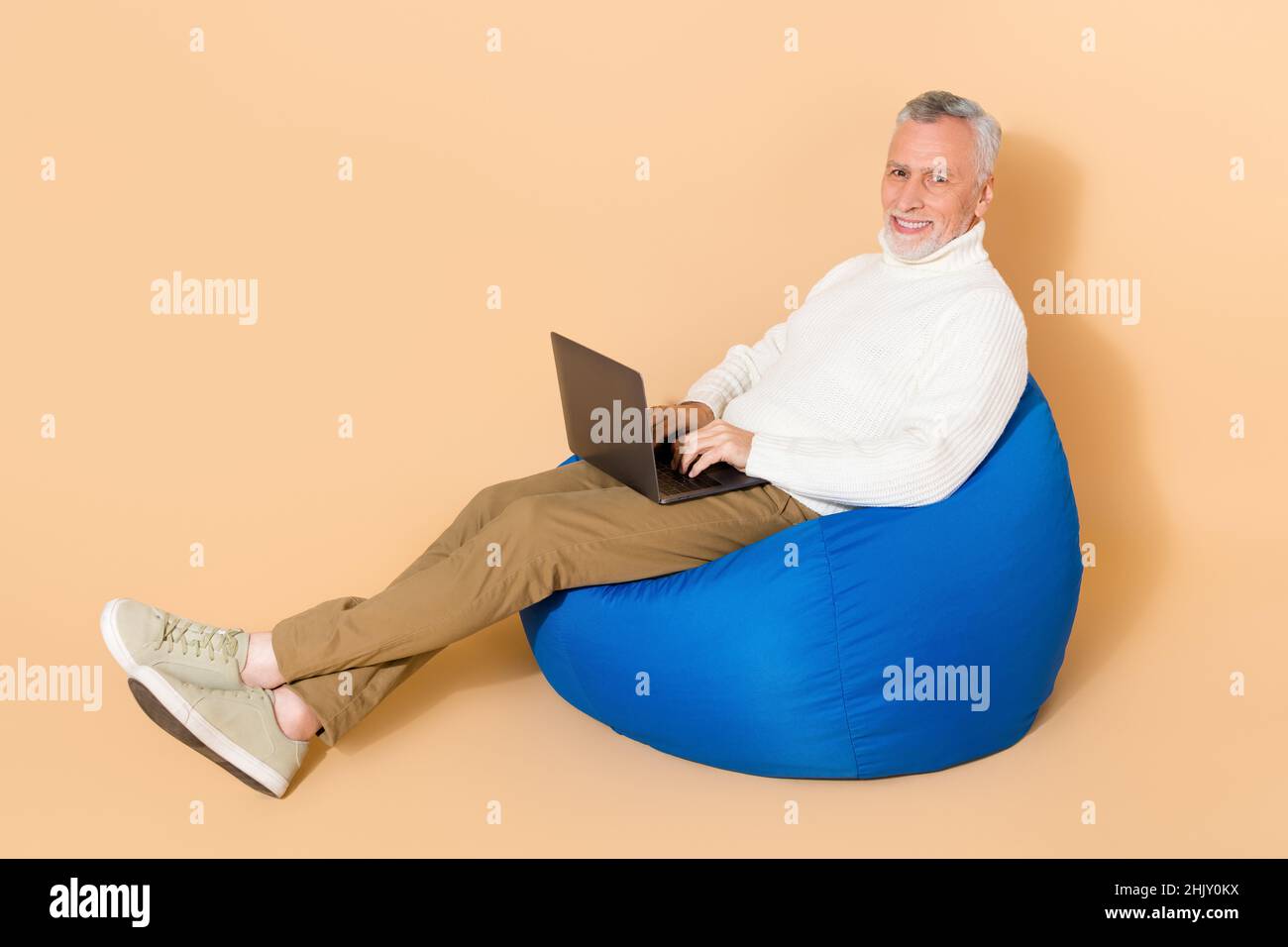Portrait of handsome trendy skilled smart clever man using laptop ...