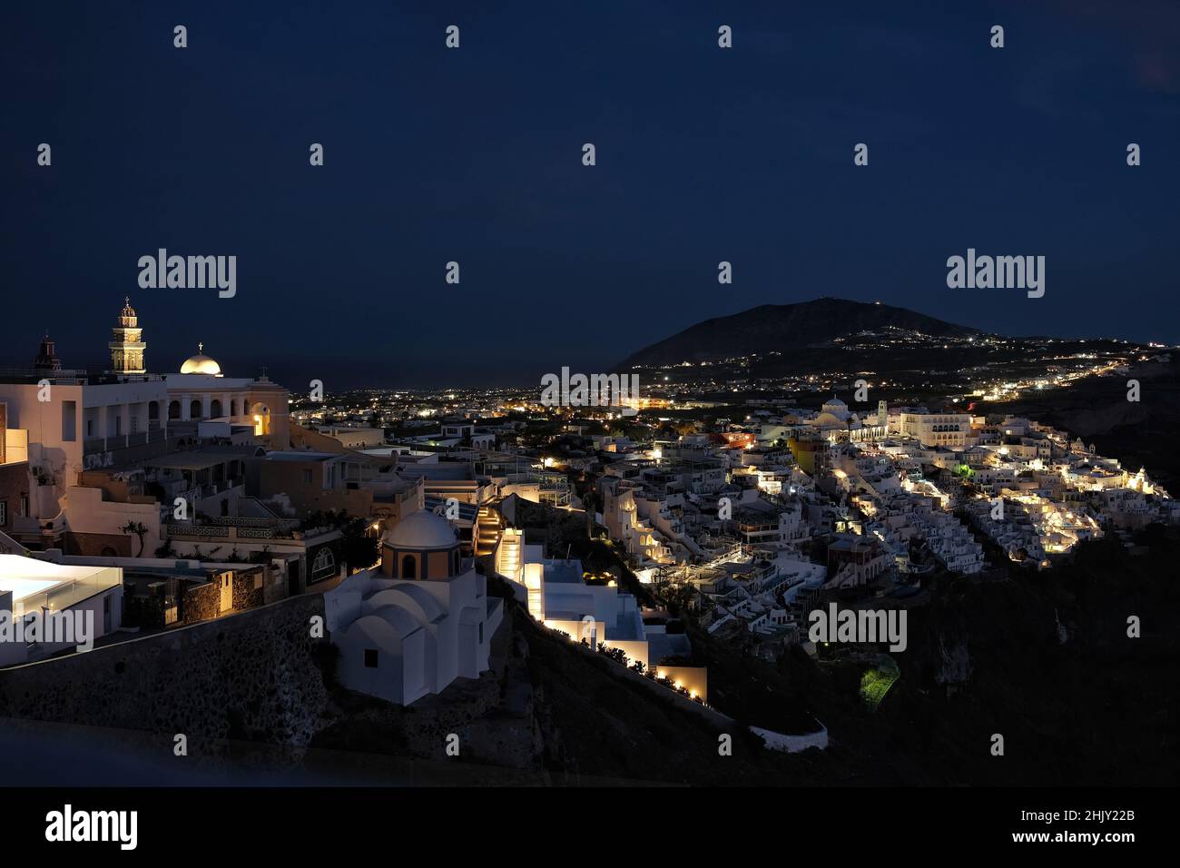 Panoramic view of the picturesque illuminated village of Fira Santorini ...
